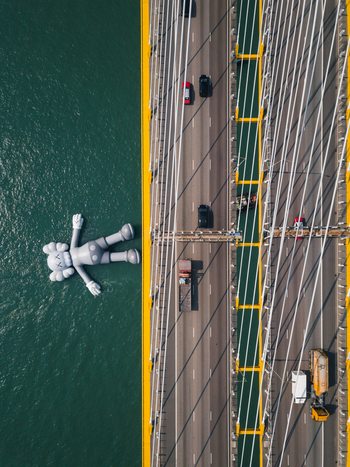 Giant KAWS figure floating in the sea on display for 10 days in Hong ...